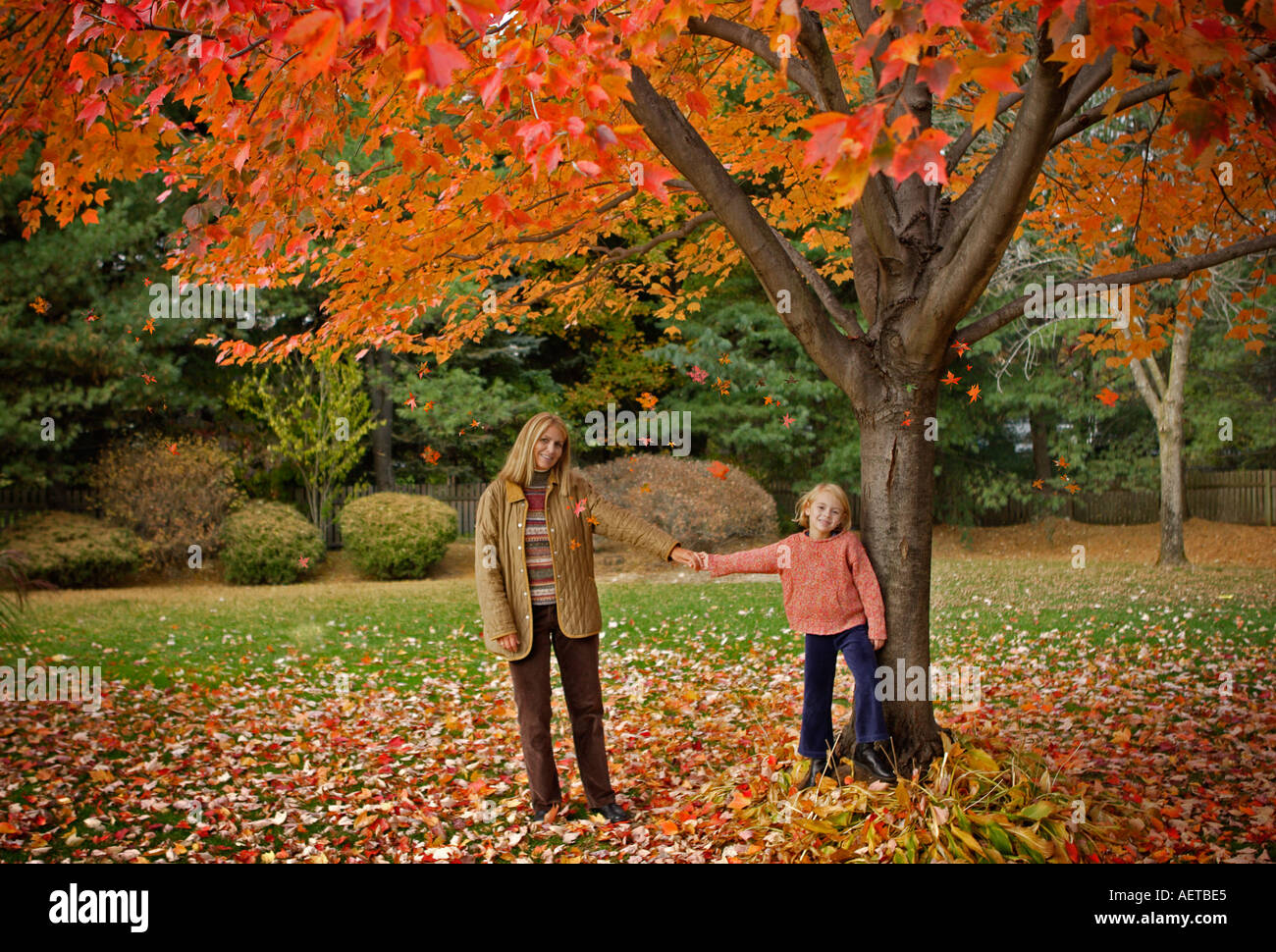 Mother and daughter under a tree Stock Photo - Alamy