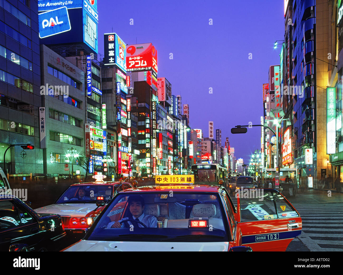 Taxis and foot traffic in Ginza district of Tokyo at night Stock Photo ...
