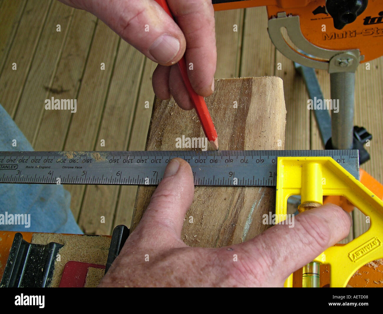 Closeup of hand and spirit level marking out timber measuring Stock ...
