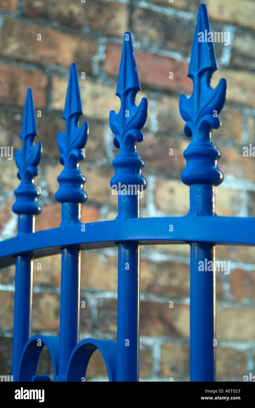 Blue iron railings gate against brick Stock Photo - Alamy