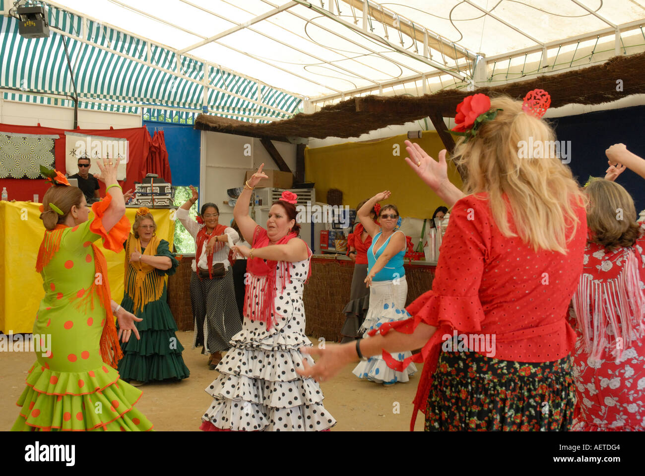 Middle -aged Spanish women dance flamenco in traditional dress on ...