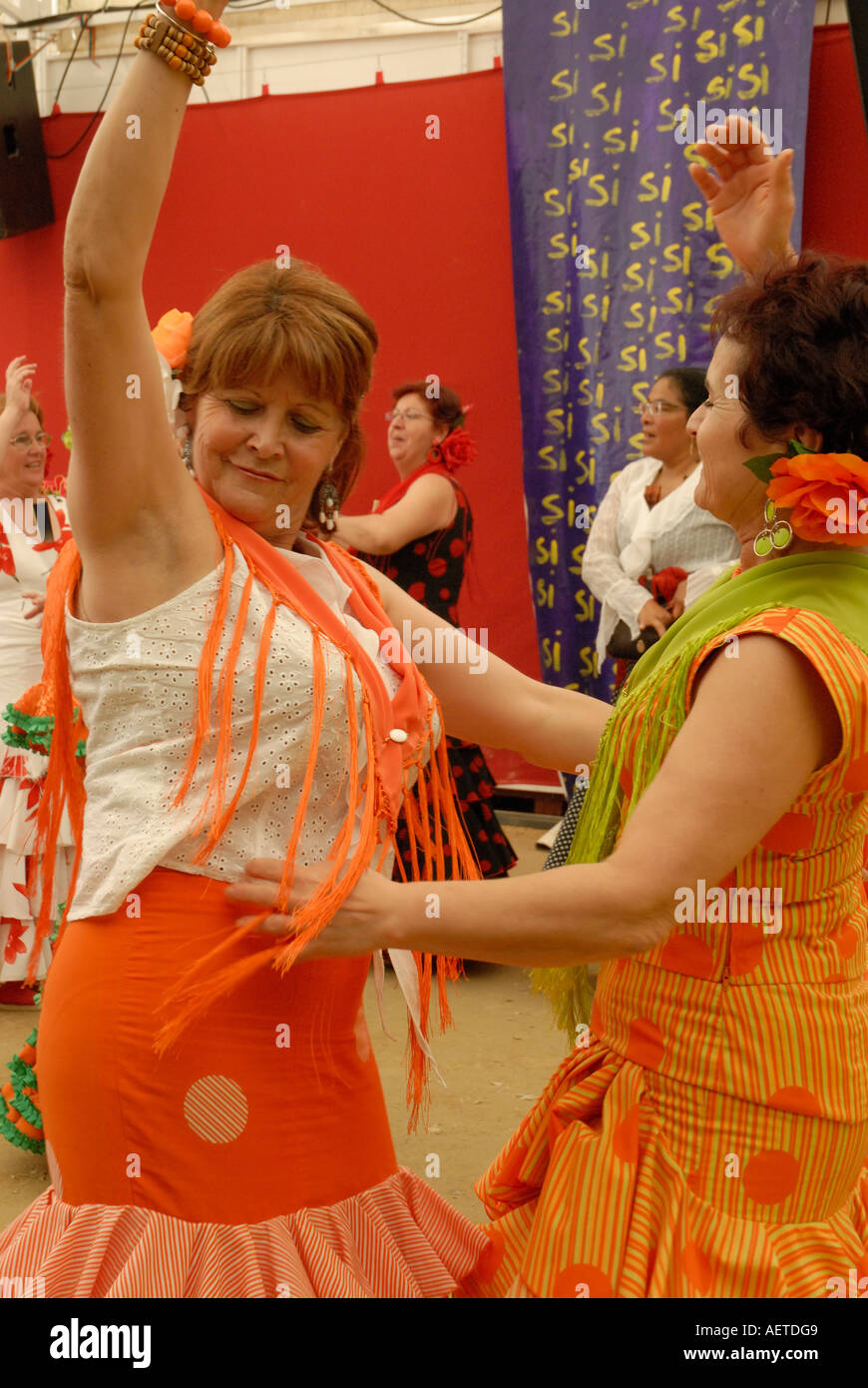 Two middle -aged Spanish women dance flamenco in traditional dress on ...