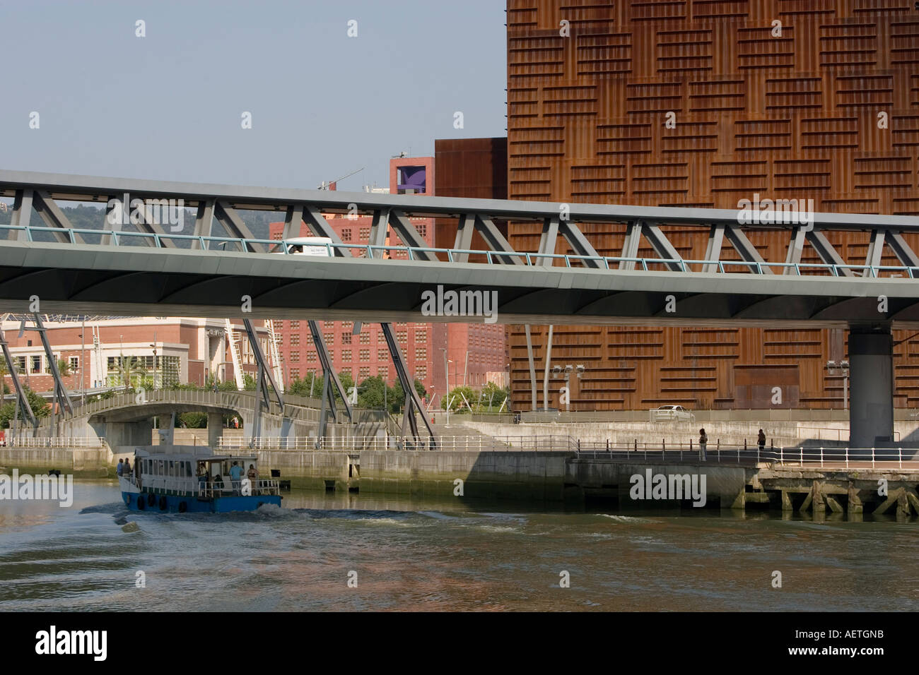 Boat on river Nervion passing under Puente Euskalduna Euskalduna Palace ...