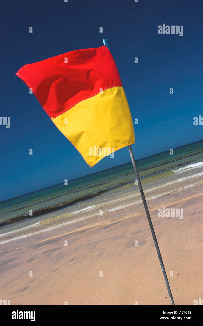 A swimming safety flag (red and yellow) on Hayle beach, Cornwall ...