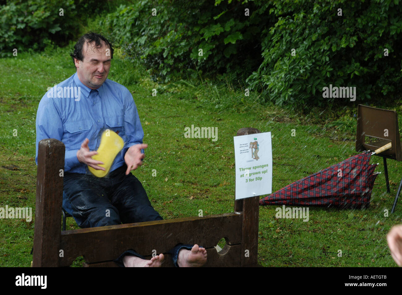 A scout leader raising money for charity by sitting in stocks and ...