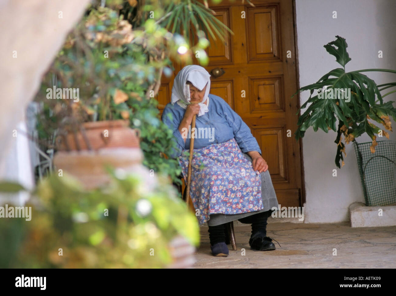 Old woman dozing at monastery Paleokastritsa Corfu Greek Islands Greece ...