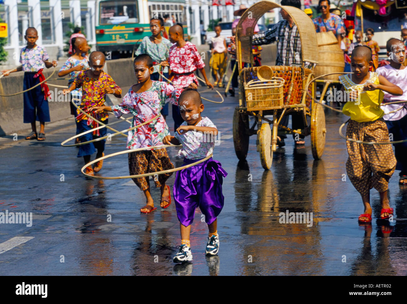 Children playing and parading in streets during King Narai Reign Fair ...