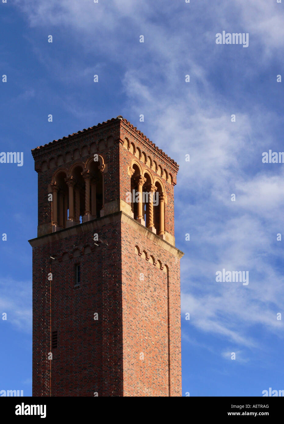 An old brick bell tower sits atop a church at a large public university ...
