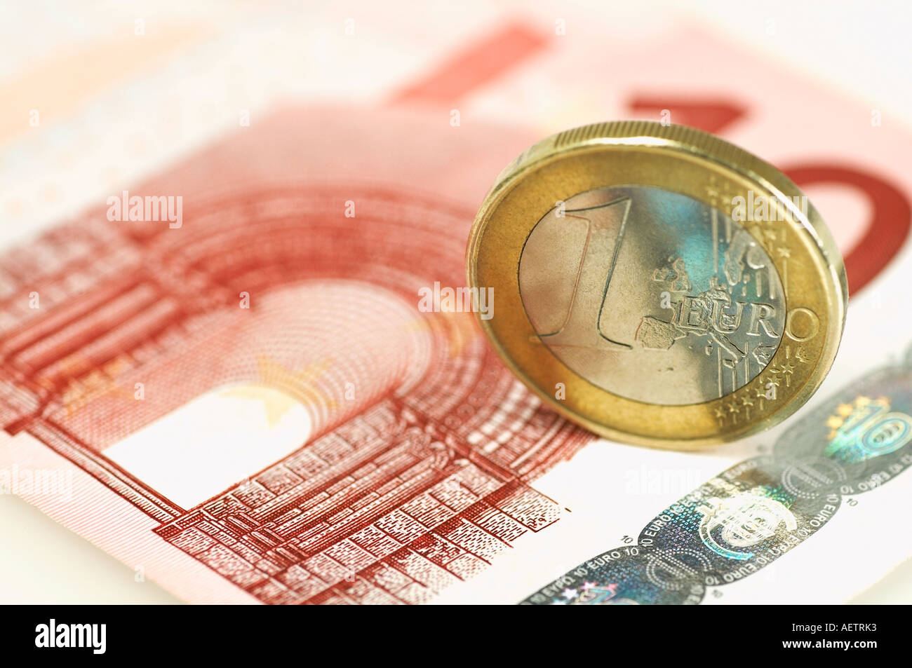Banknote of ten Euros and coin of one Euro Stock Photo - Alamy