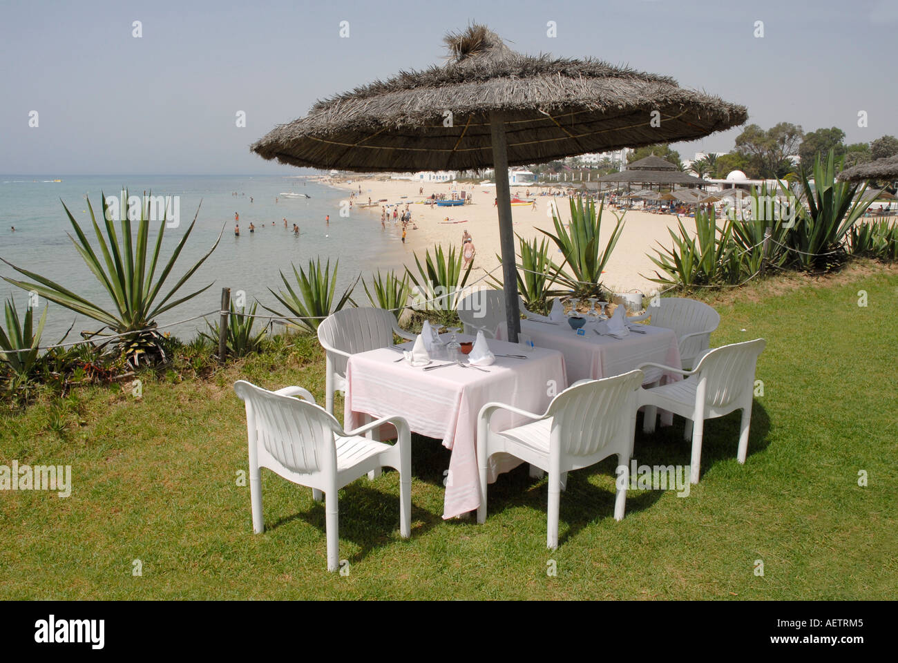 Table set in the shade overlooking the sea Stock Photo - Alamy