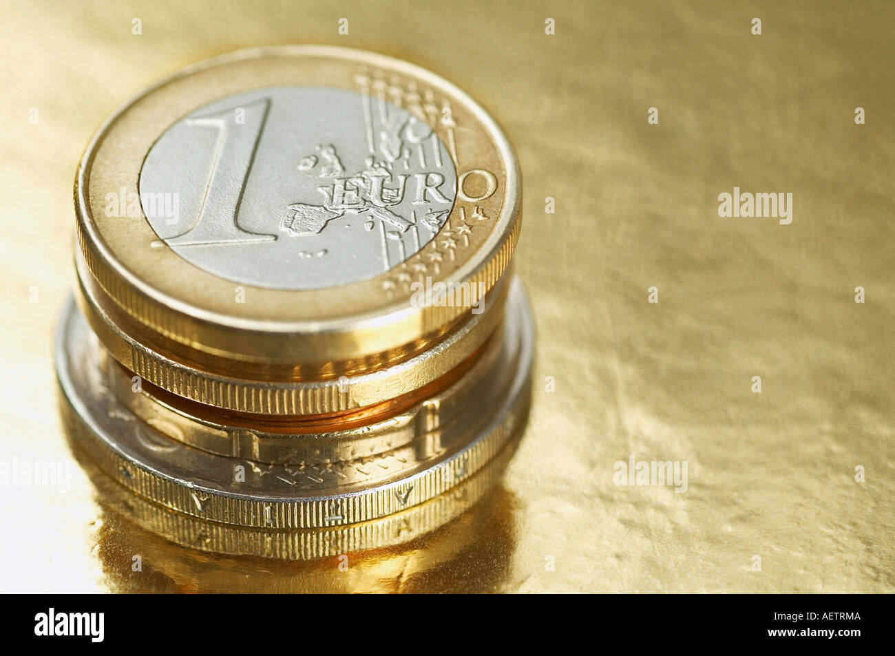 Stack of euros and eurocents on golden background Stock Photo - Alamy