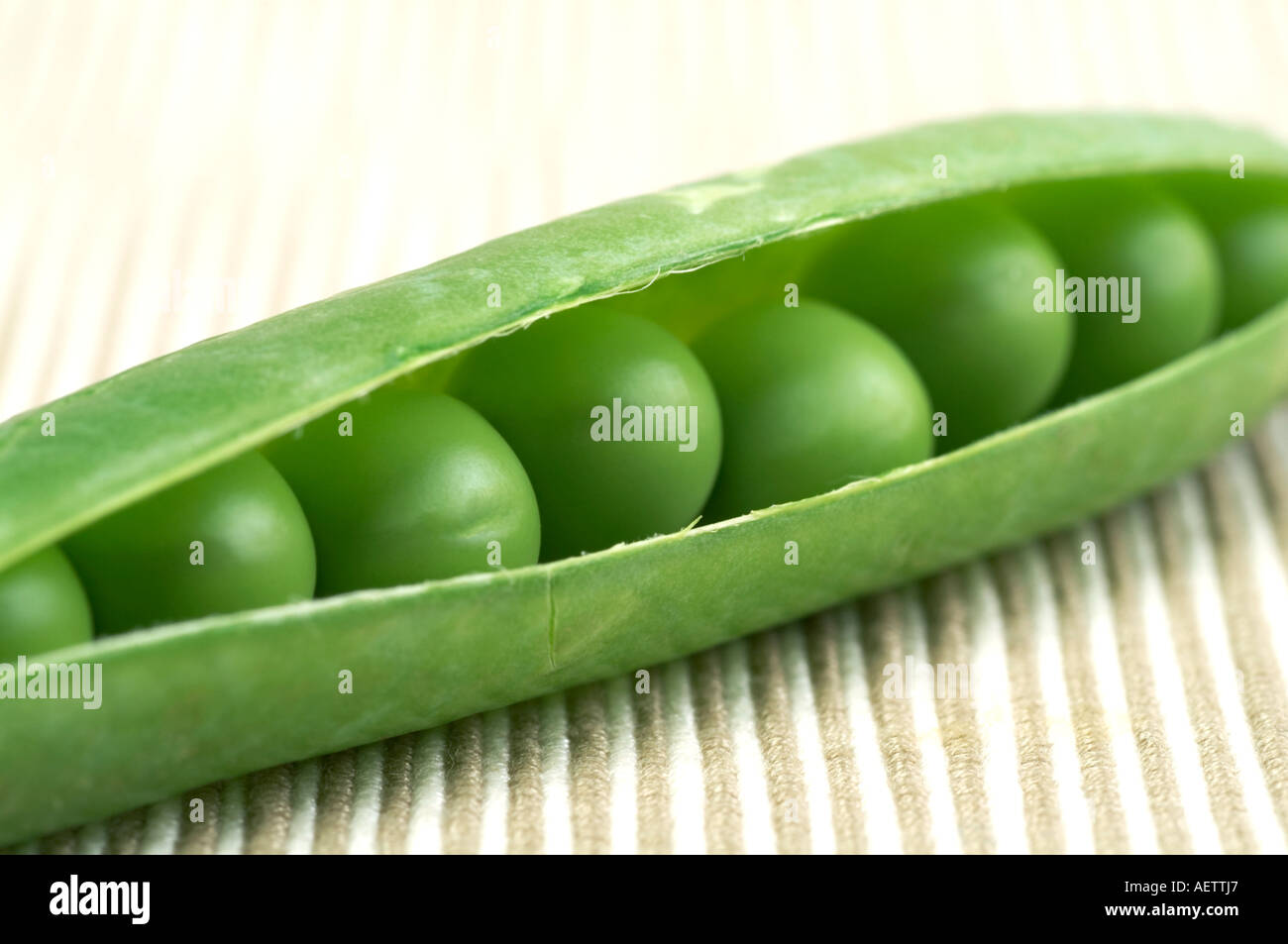 Macro pea pod on stripped background Stock Photo - Alamy