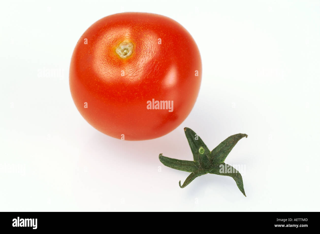 Cherry tomato without its stipe on white background Stock Photo - Alamy