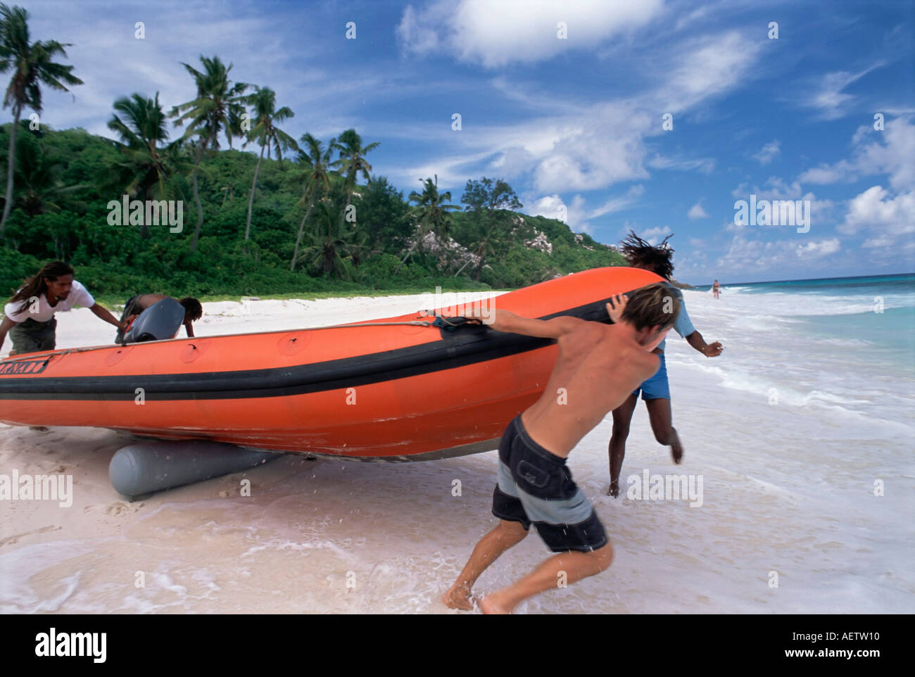 Launching inflatable boat on beach nature reserve Ile Aride Aride ...