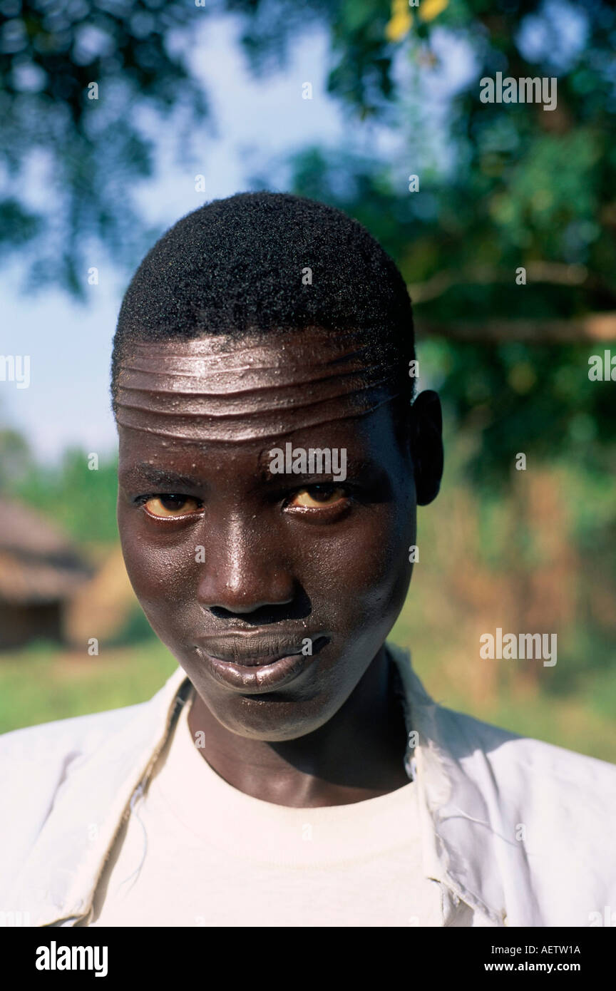 Head and shoulders portrait of a Nuer man with forehead scarification ...