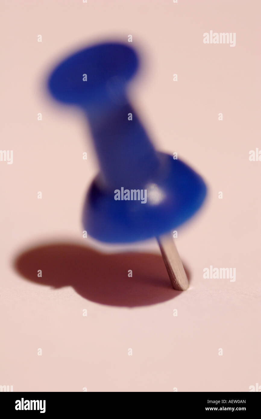 Blue pin stuck in paper close up Stock Photo - Alamy