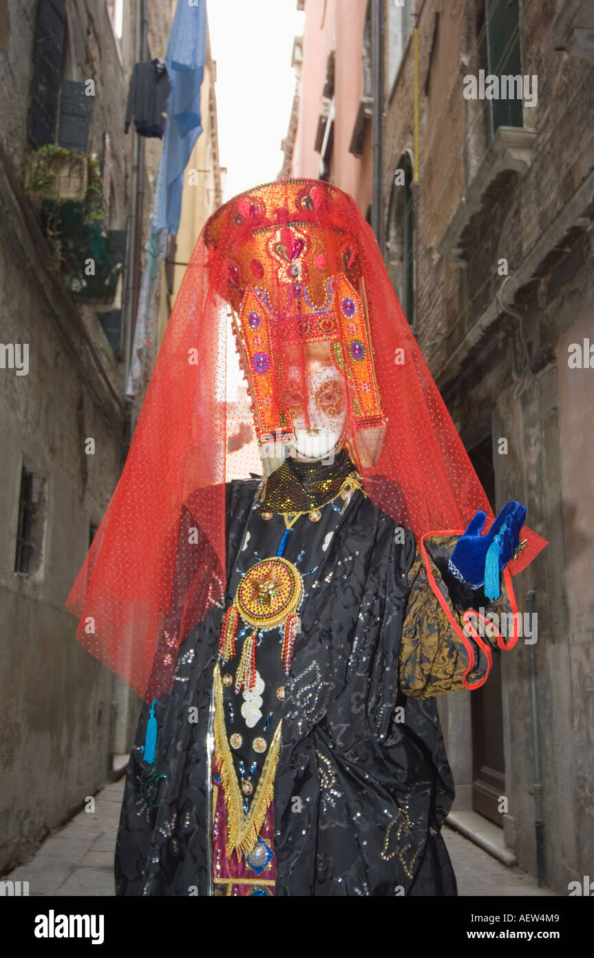 masked faces and costumes in alley backstreet at the Venice Carnival ...