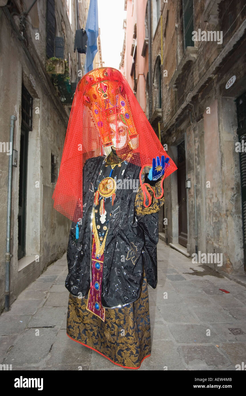 masked faces and costumes in alley backstreet at the Venice Carnival ...