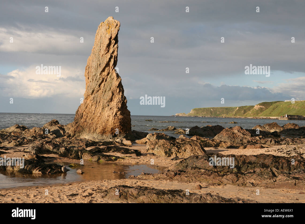 Red rock quartzite sea stacks on the shore at picturesque fishing ...
