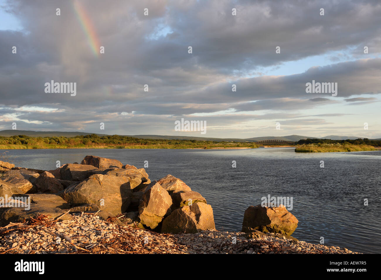 Rainbow Evening sunlight as sunsets at Spey Bay vegetated shingle at ...