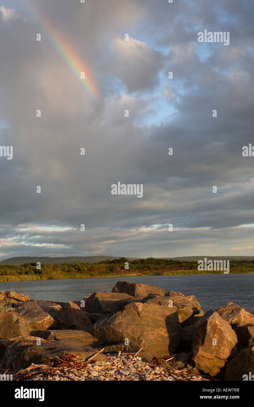 Rainbow Evening sunlight as sunsets at Spey Bay vegetated shingle at ...