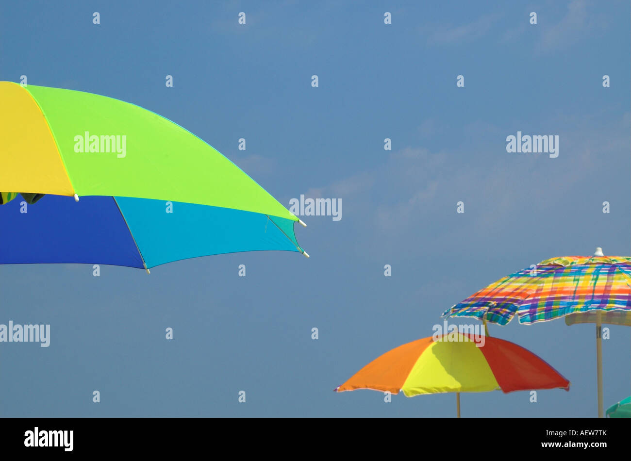 A trio of colourful summer beach umbrellas Stock Photo - Alamy