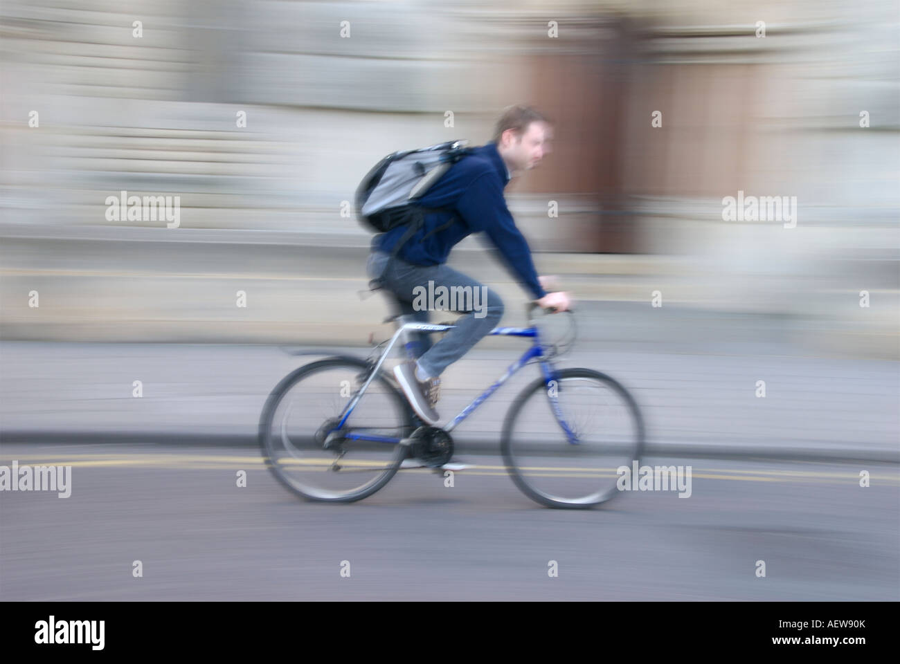 Male cyclist speeding down a street in Oxford City Centre Stock Photo ...