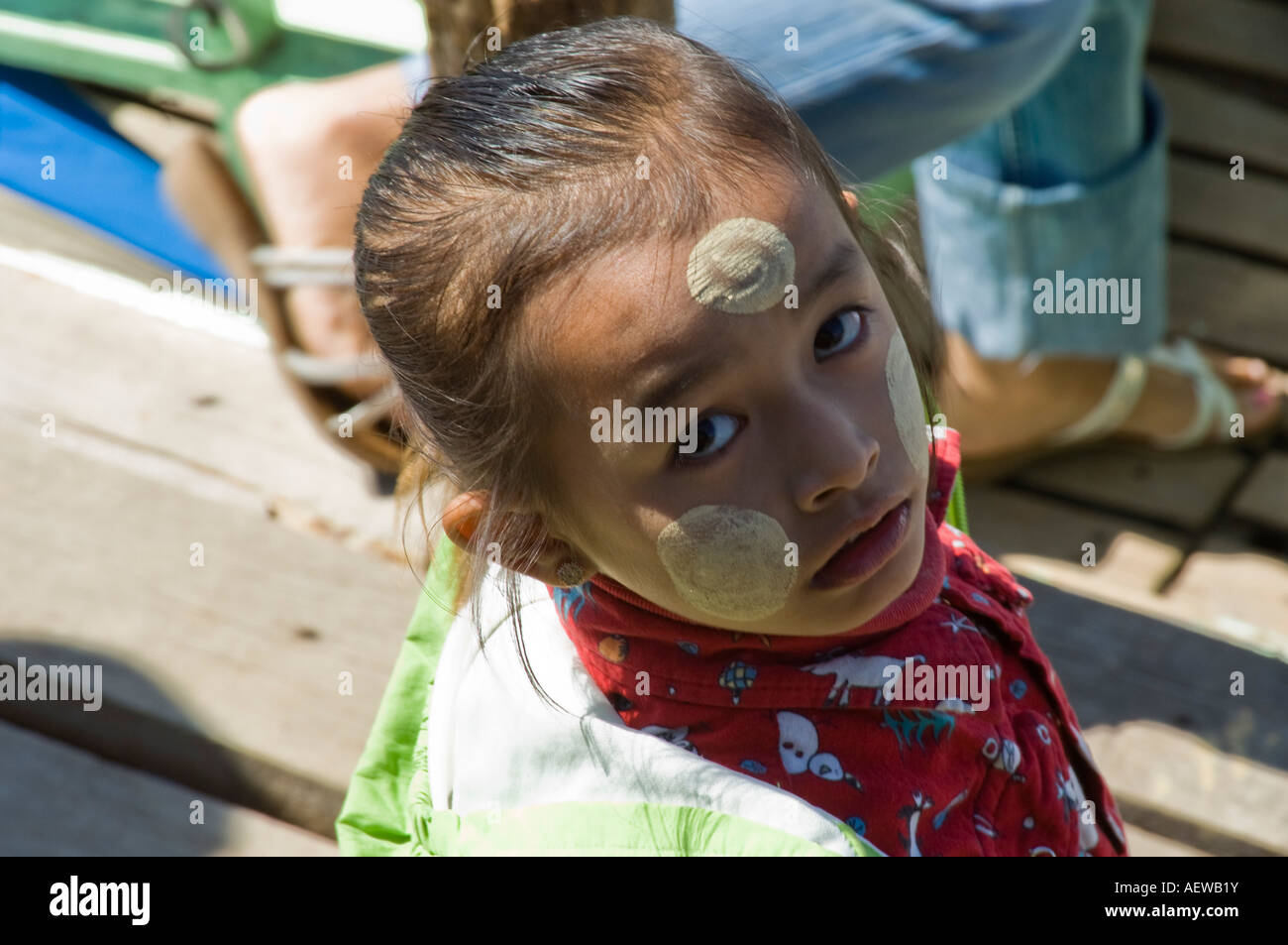 A young girl with face covered in tanaka paste in Inle Lake, Myanmar ...