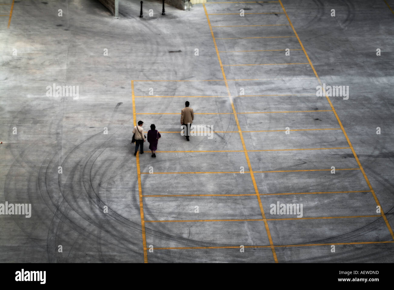 Elevated view of people in a deserted car park Stock Photo - Alamy