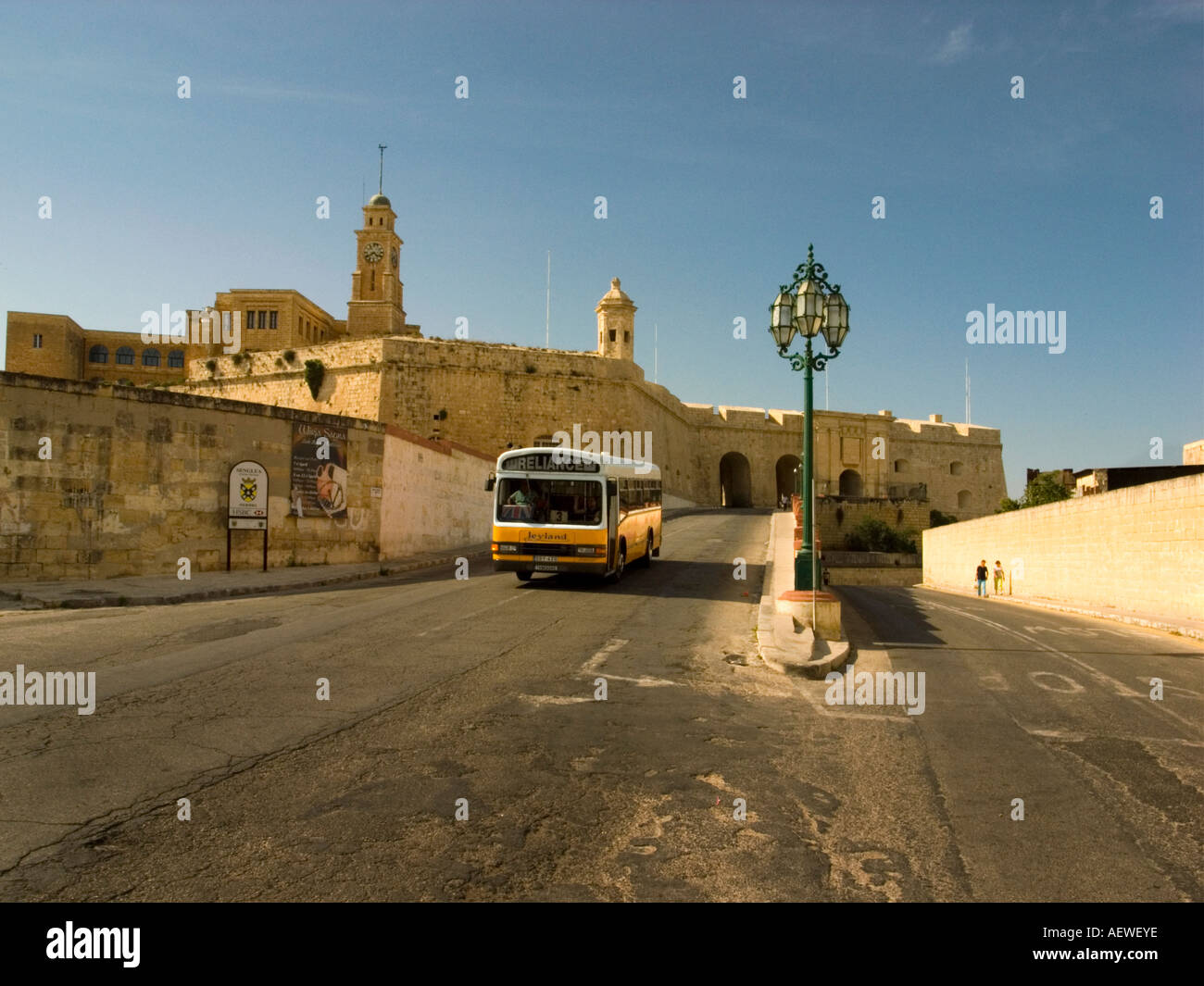 Maltese bus on the old streets of Birgu with The Margerita Gate at the ...