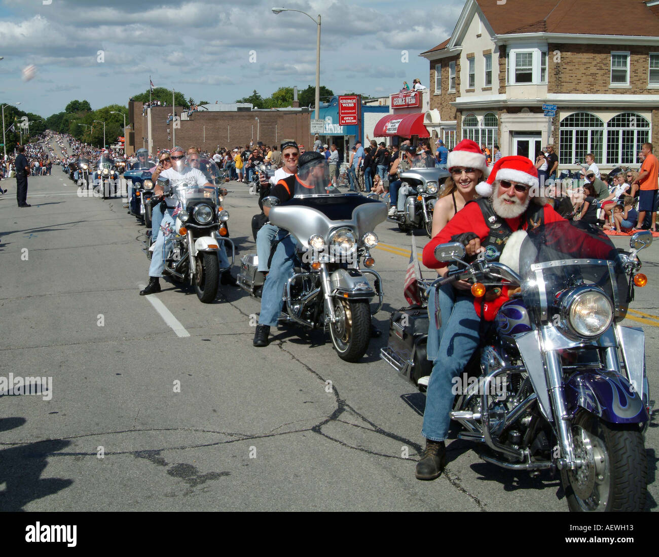 A couple dressed as mrs and santa clause on their harley davidson ...