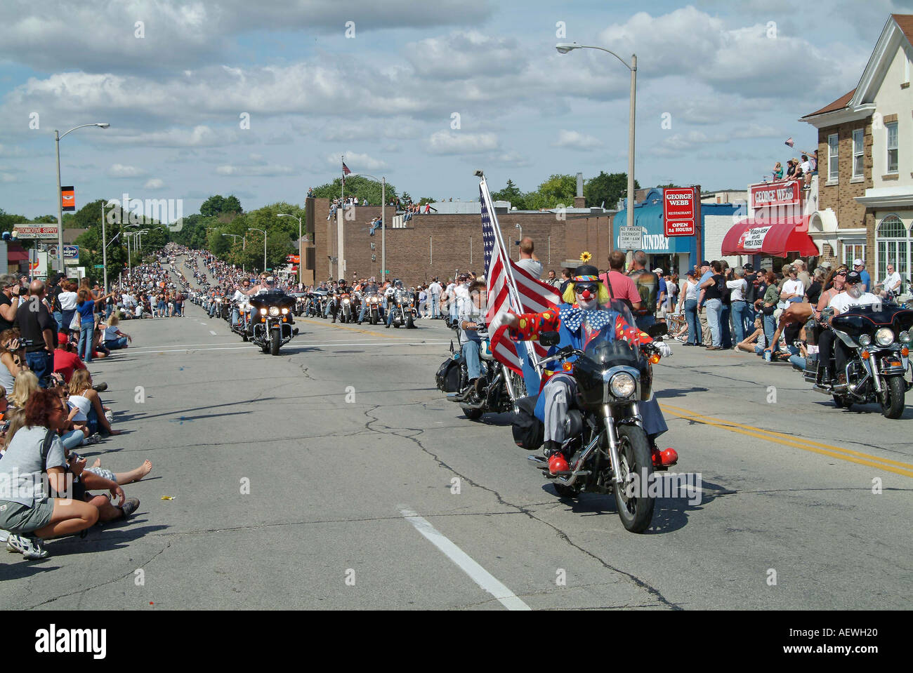 A man dressed as clown riding on his harley davidson motorcycle ...
