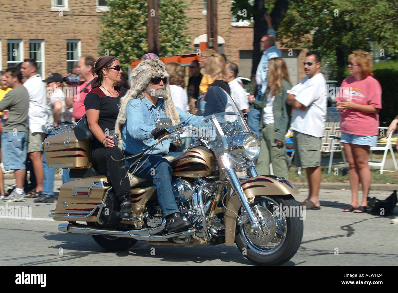 A couple with man wearing a fox hat riding their harley davidson ...