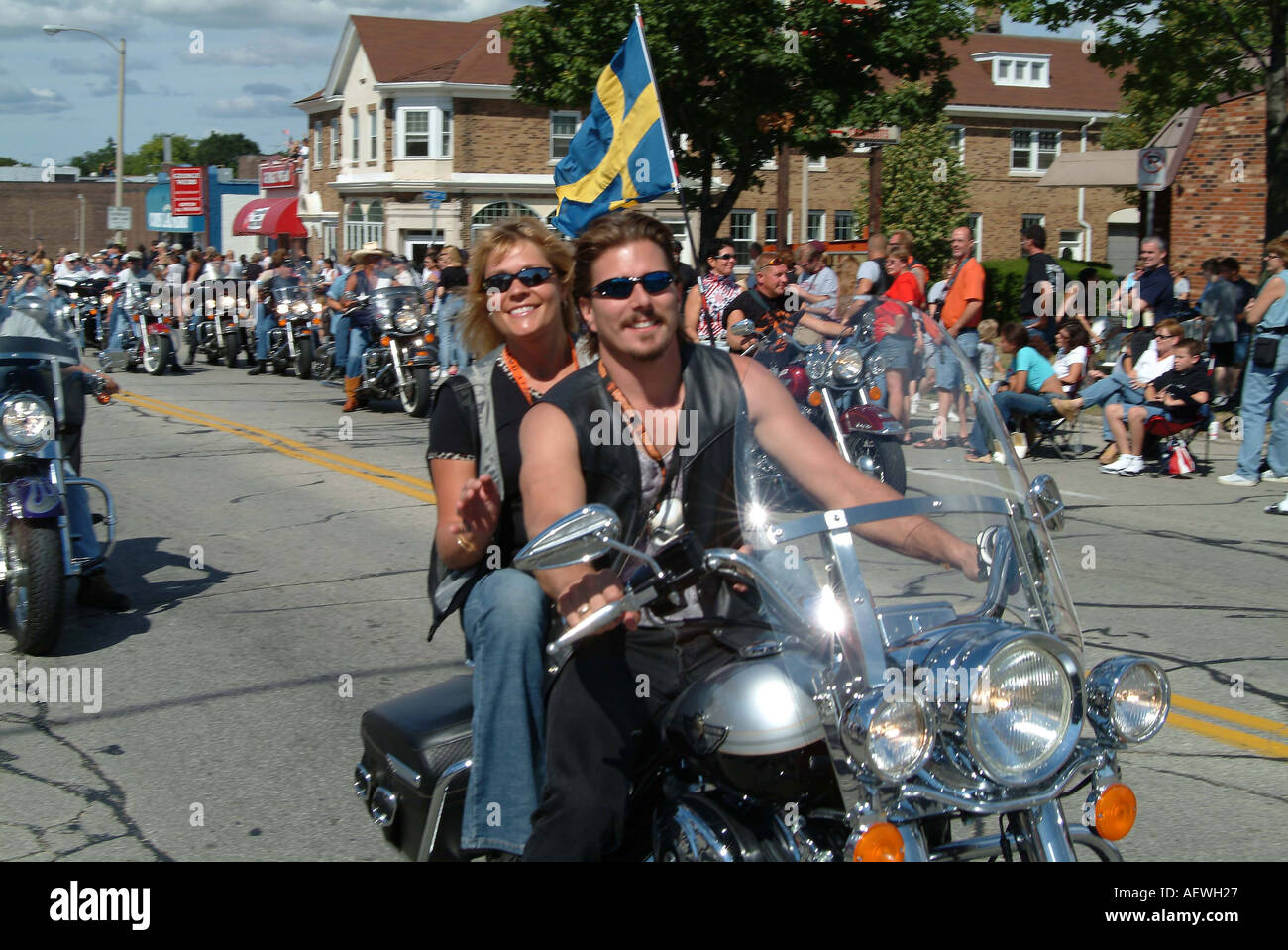 A young couple riding their harley davidson motorcycle happily in the ...