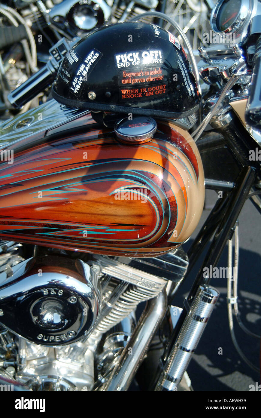 Side view of a parked Harley davidson motorcycle with stickered helmet ...