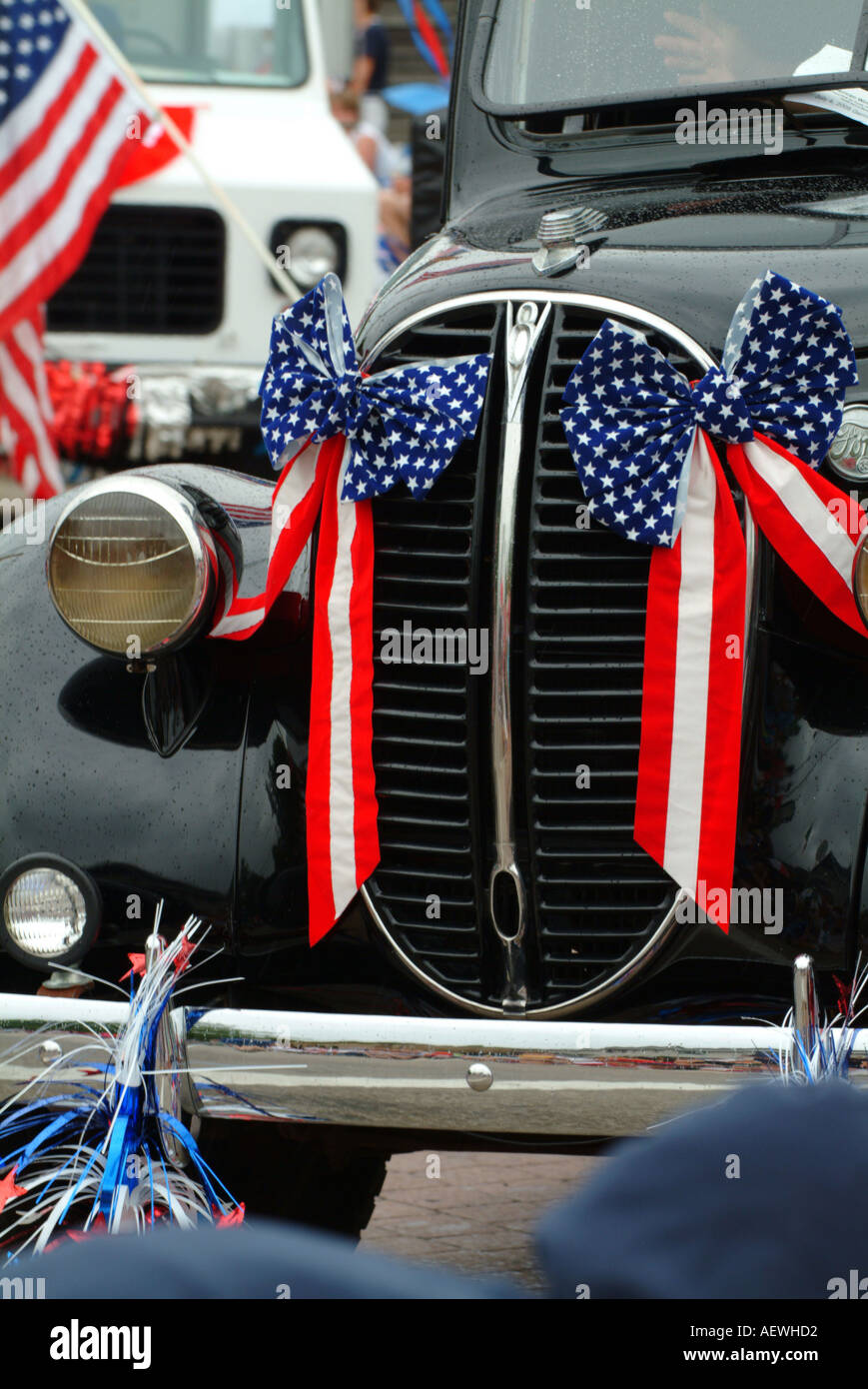 Front grill of an old ford black truck decorated with american flags ...