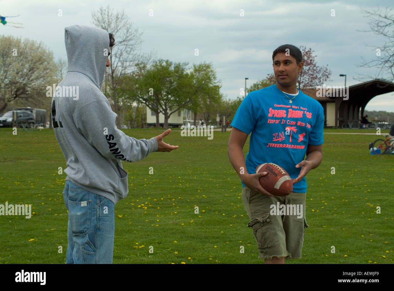 Two boys playing football in park hi-res stock photography and images ...
