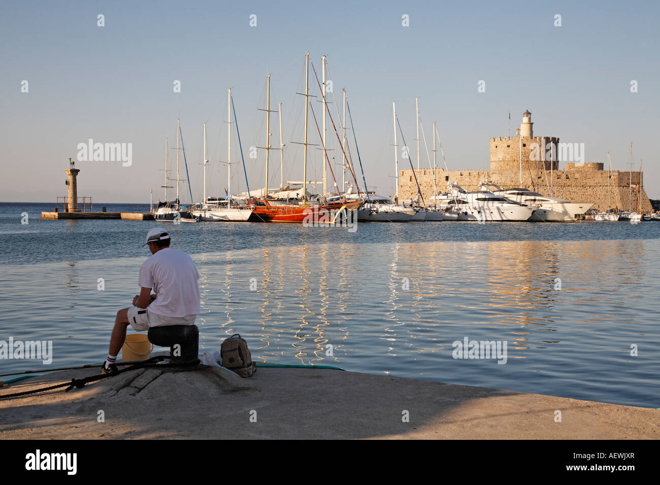 Man Fishing In Harbour Rhodes Town Rhodes Greece Hellas Stock Photo - Alamy