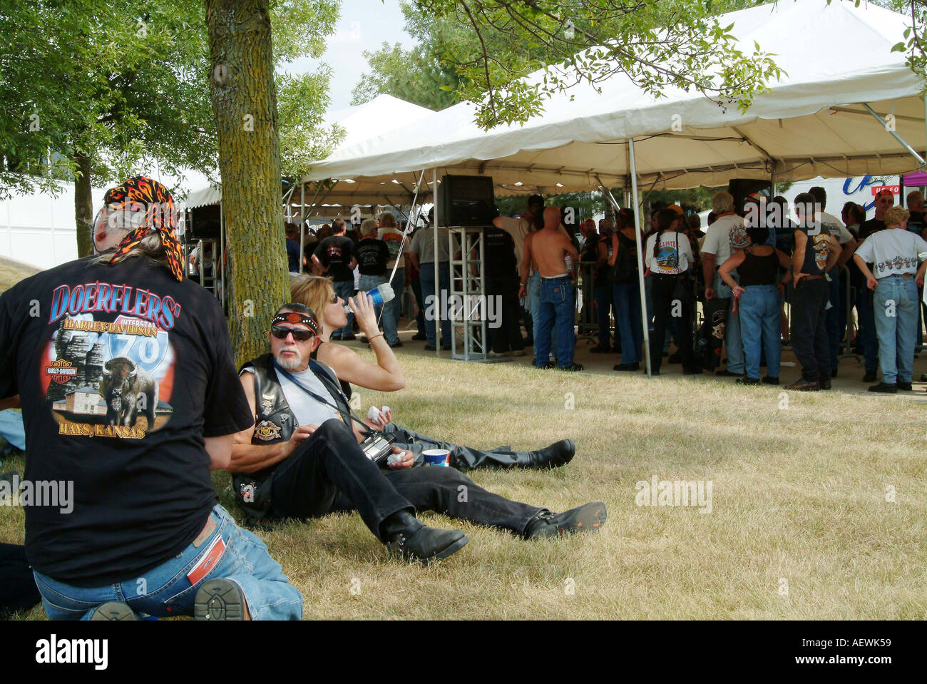 Harley davidson fans entering the plant while others are sitting around ...