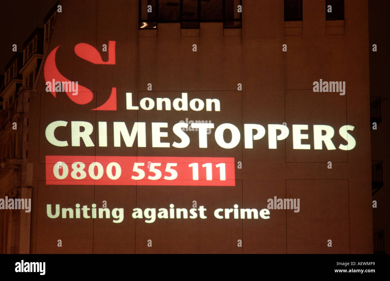 Crimestoppers logo beamed onto a wall at night in London, UK Stock ...