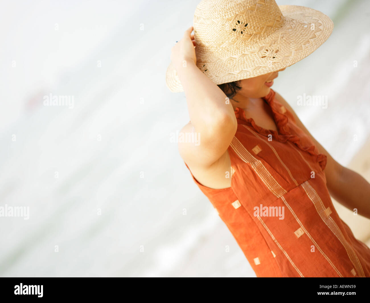 Side profile of a young woman standing on the beach Stock Photo - Alamy