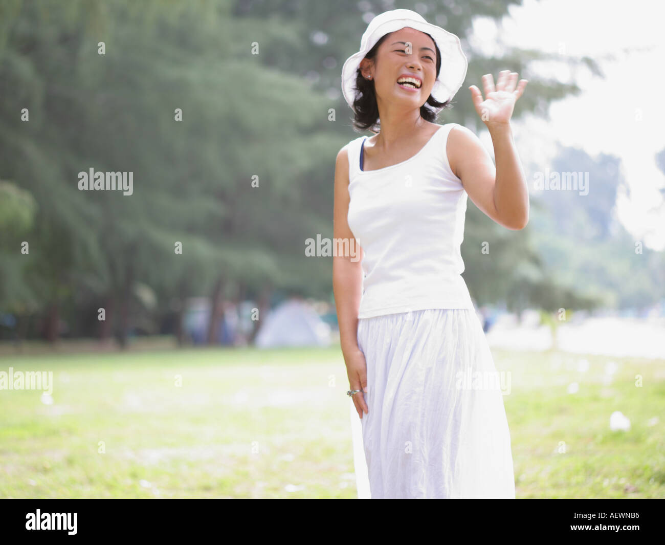 Woman waving a sun hat hi-res stock photography and images - Alamy