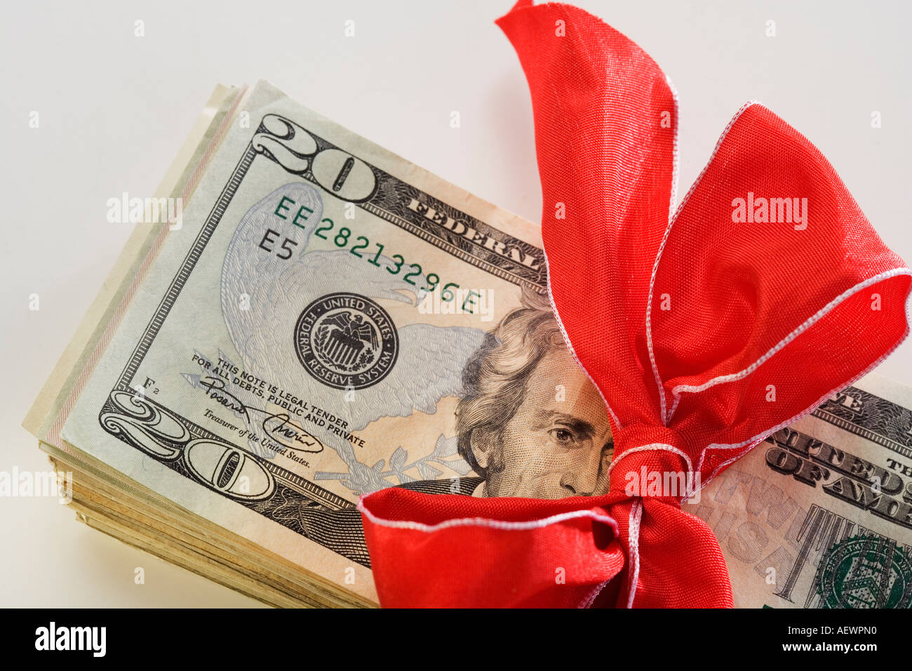 A stack of money with a bow Stock Photo - Alamy