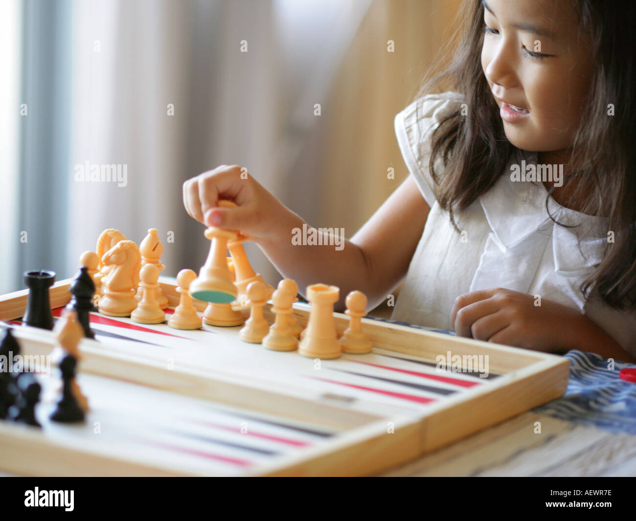 Girl holding chess pieces Stock Photo - Alamy