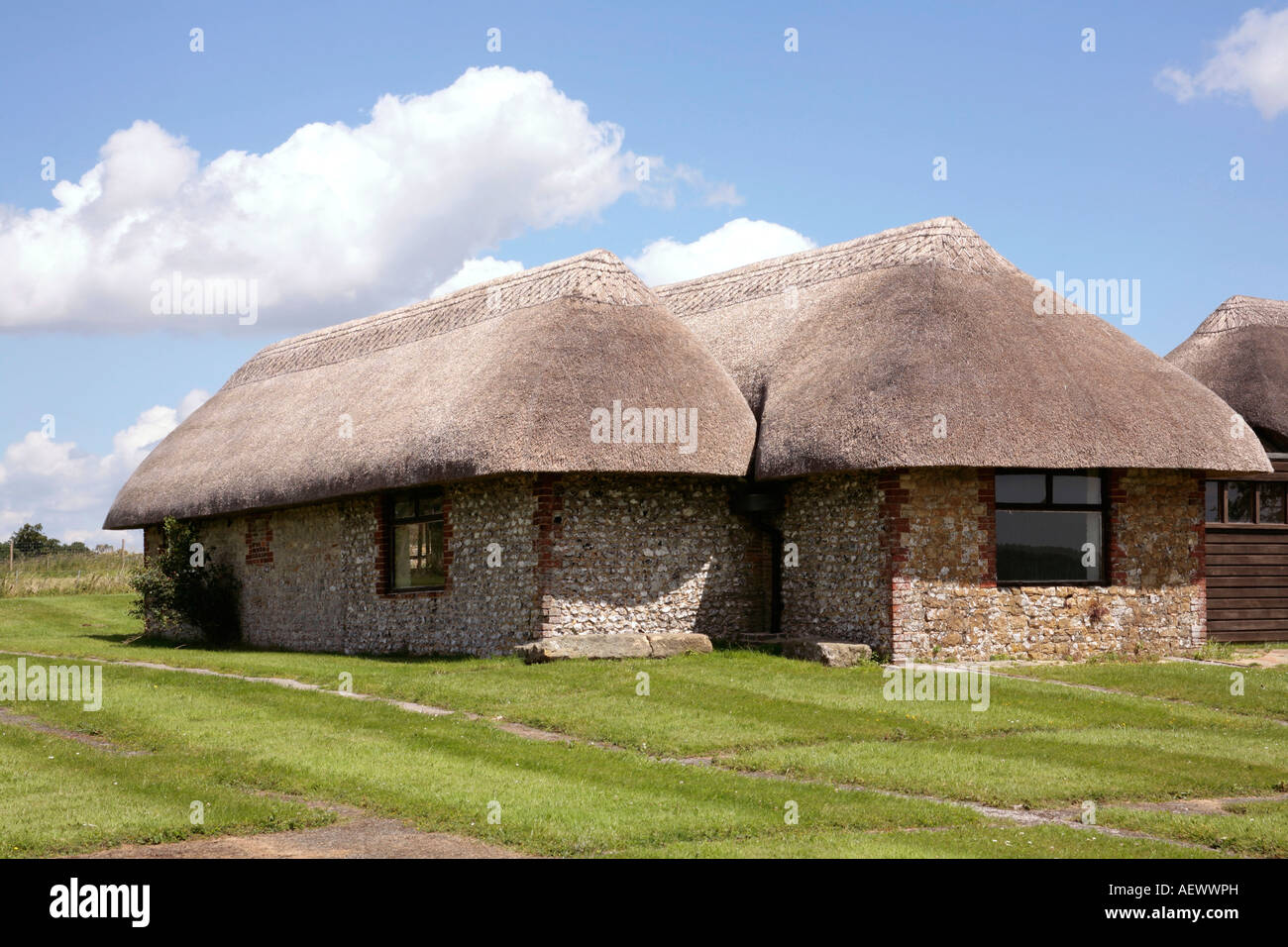 Two old English thatched stone barns housing mosaics from Bignor Roman ...
