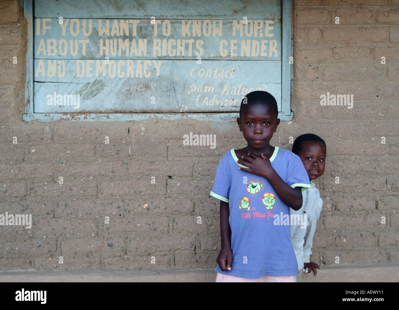 Children by a sign promoting human rights and democracy. Lake Malawi ...