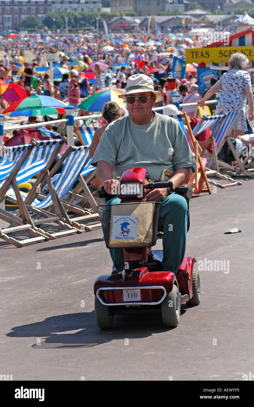 Senior male riding a disability Scooter or handicapped buggy Stock ...