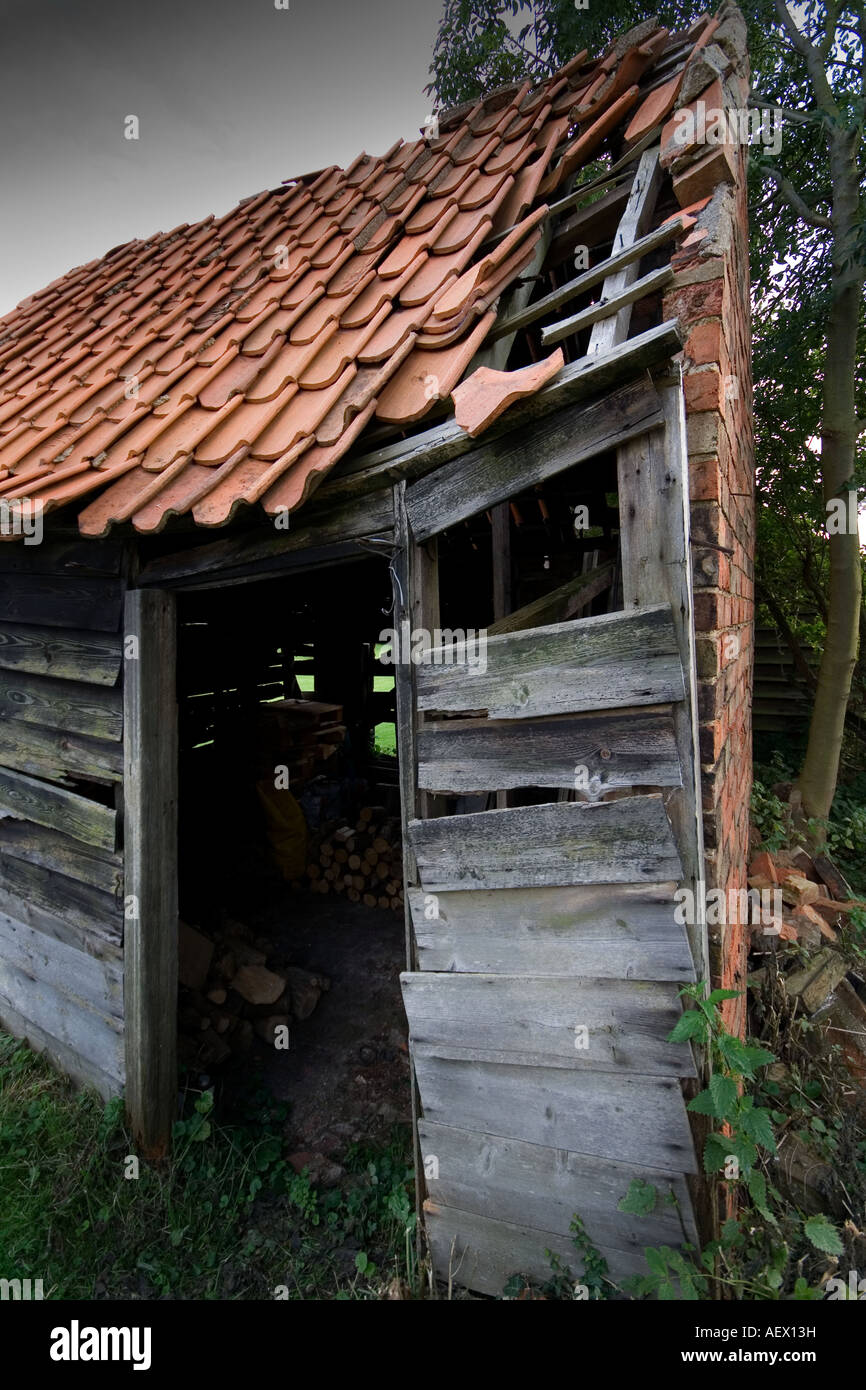 Old garden shed with decaying walls and roof Stock Photo - Alamy