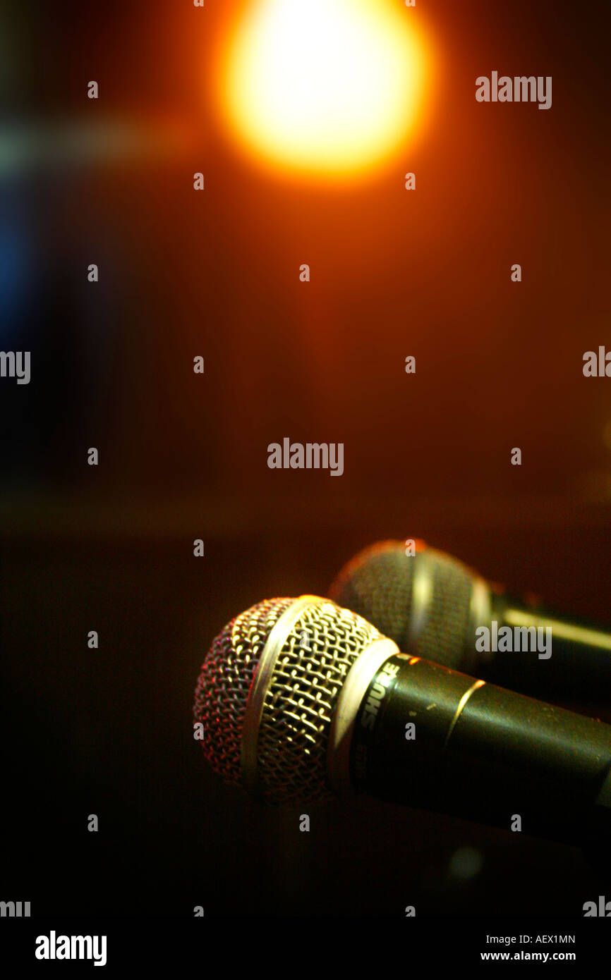 Microphones on an empty stage Stock Photo - Alamy