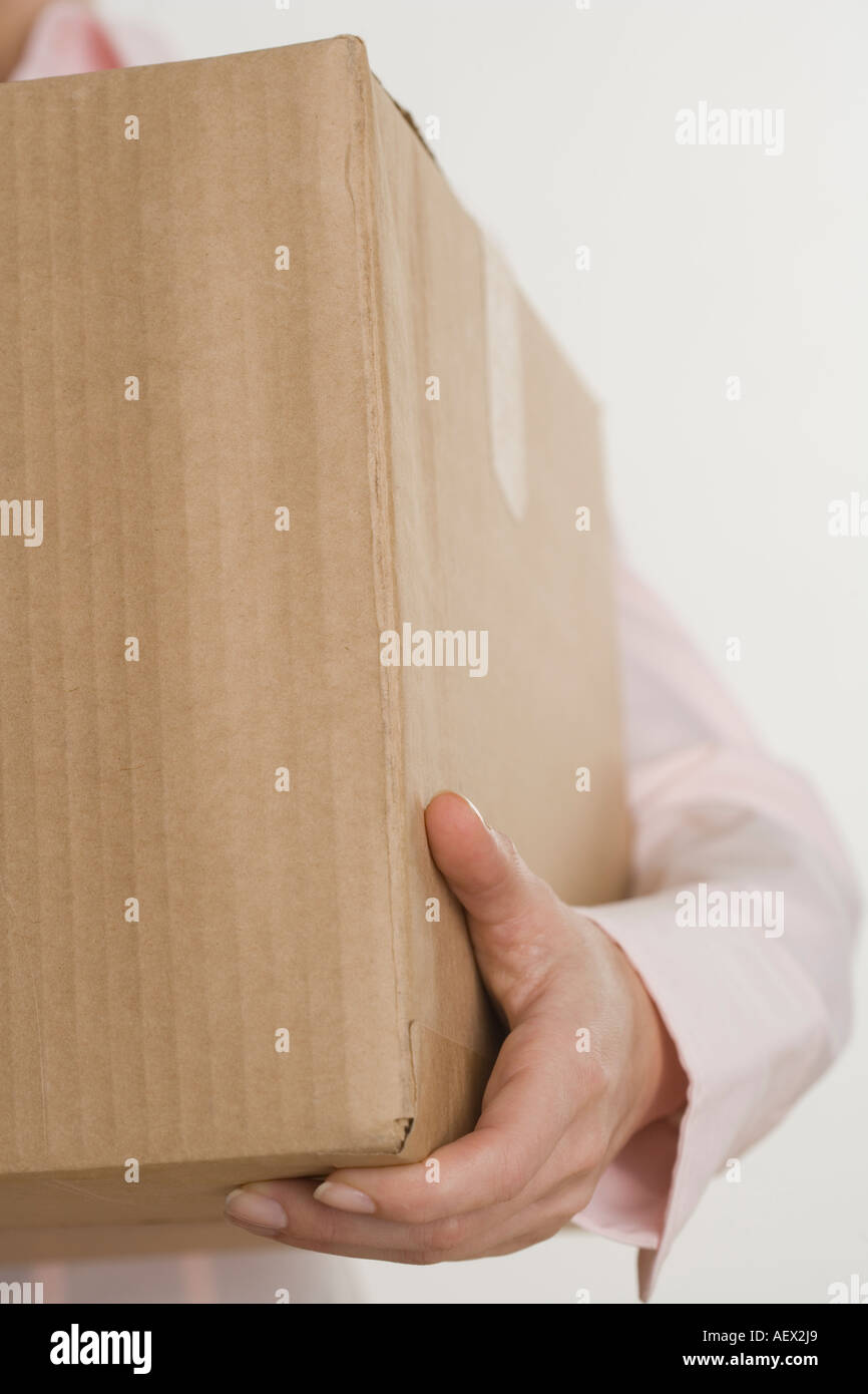 Woman carrying a box Stock Photo - Alamy